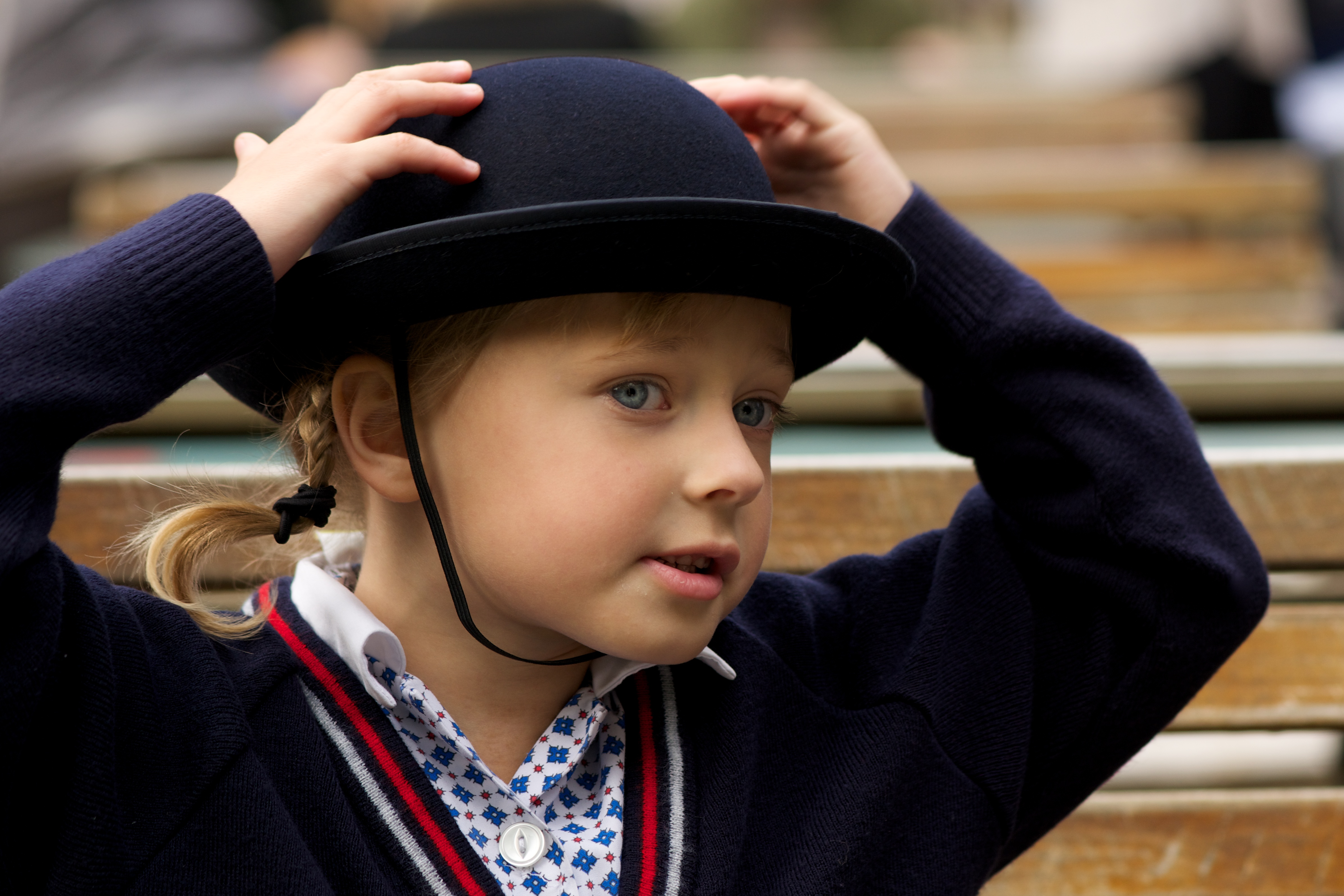 Girl putting on blue hat on bench - Nick Dale - Private Tutor