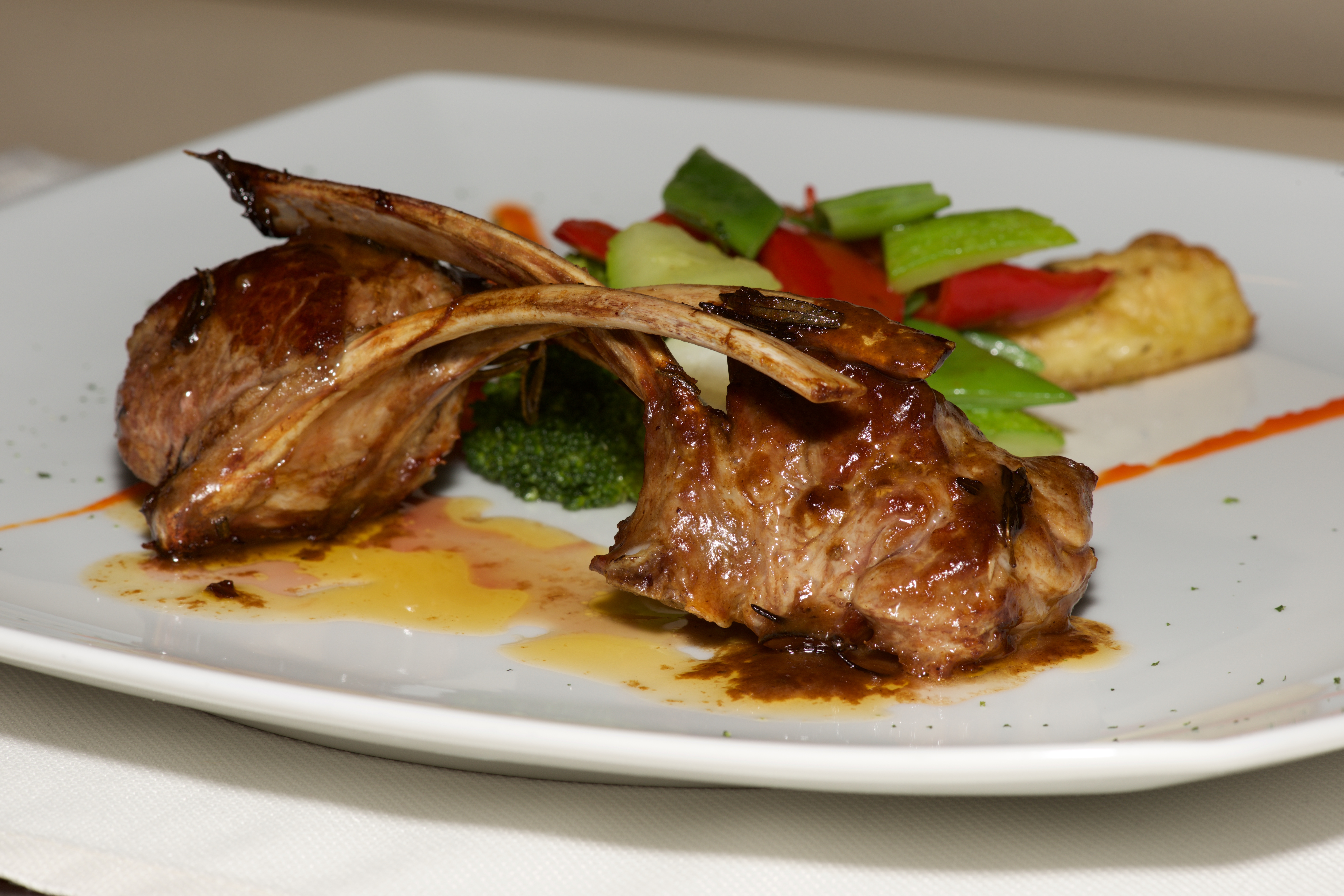 Lamb cutlets with vegetables on white plate - Nick Dale - Private Tutor