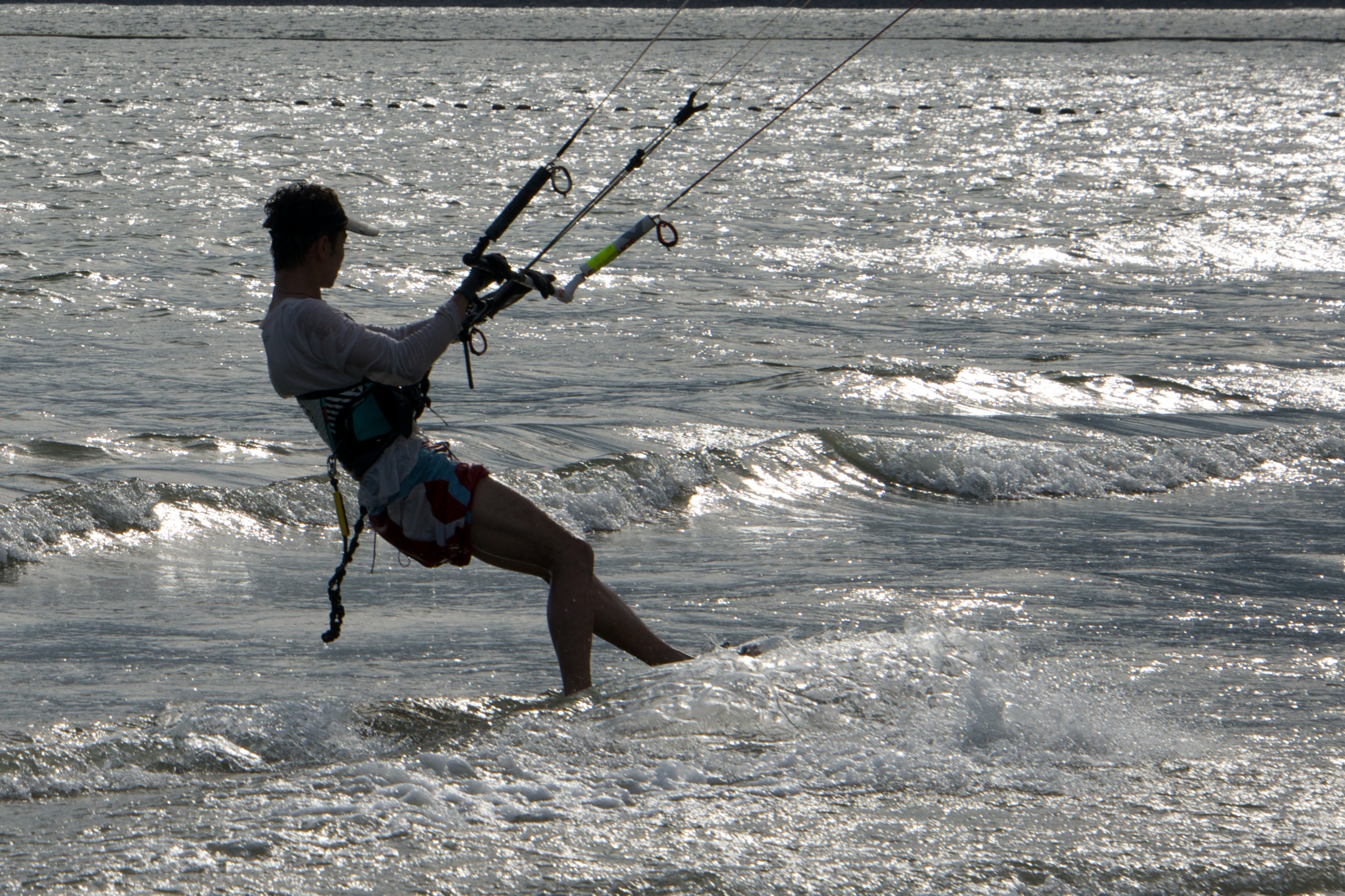 Male kite surfer backlit close to shore - Nick Dale - Private Tutor