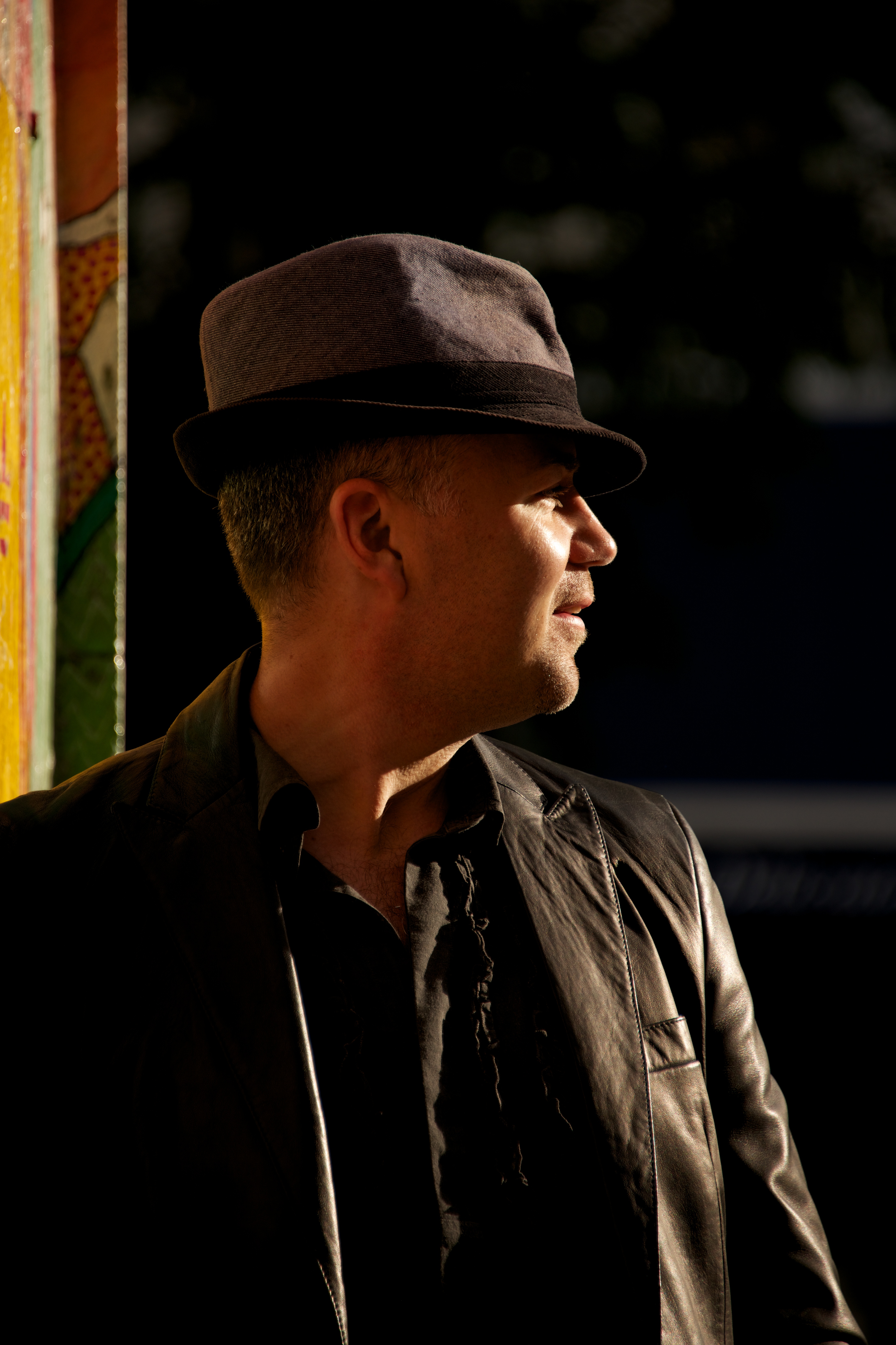 Sunlit man in hat against dark background - Nick Dale - Private Tutor
