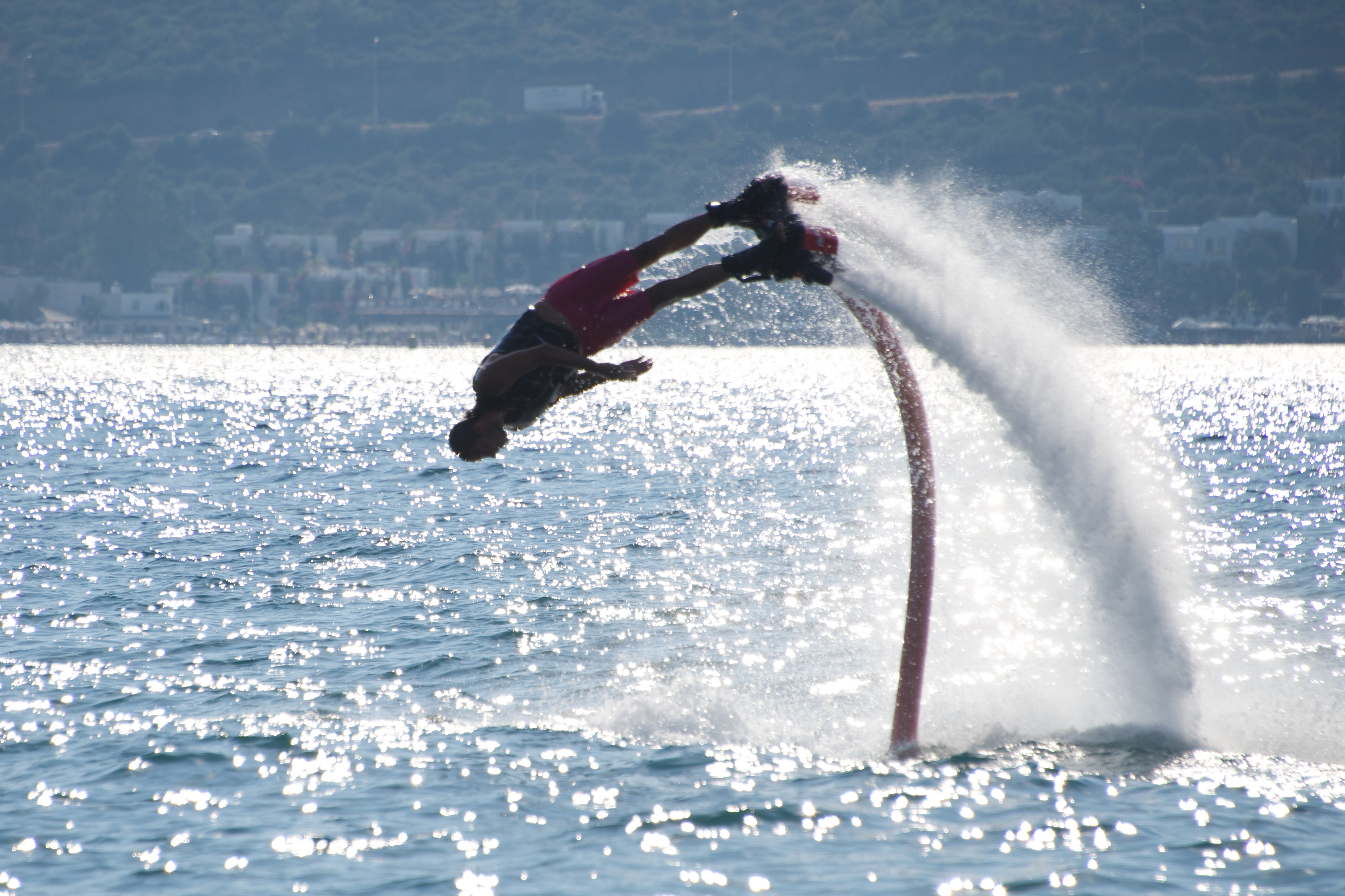 Flyboarder diving headfirst leaving arc of spray - Nick Dale - Private ...