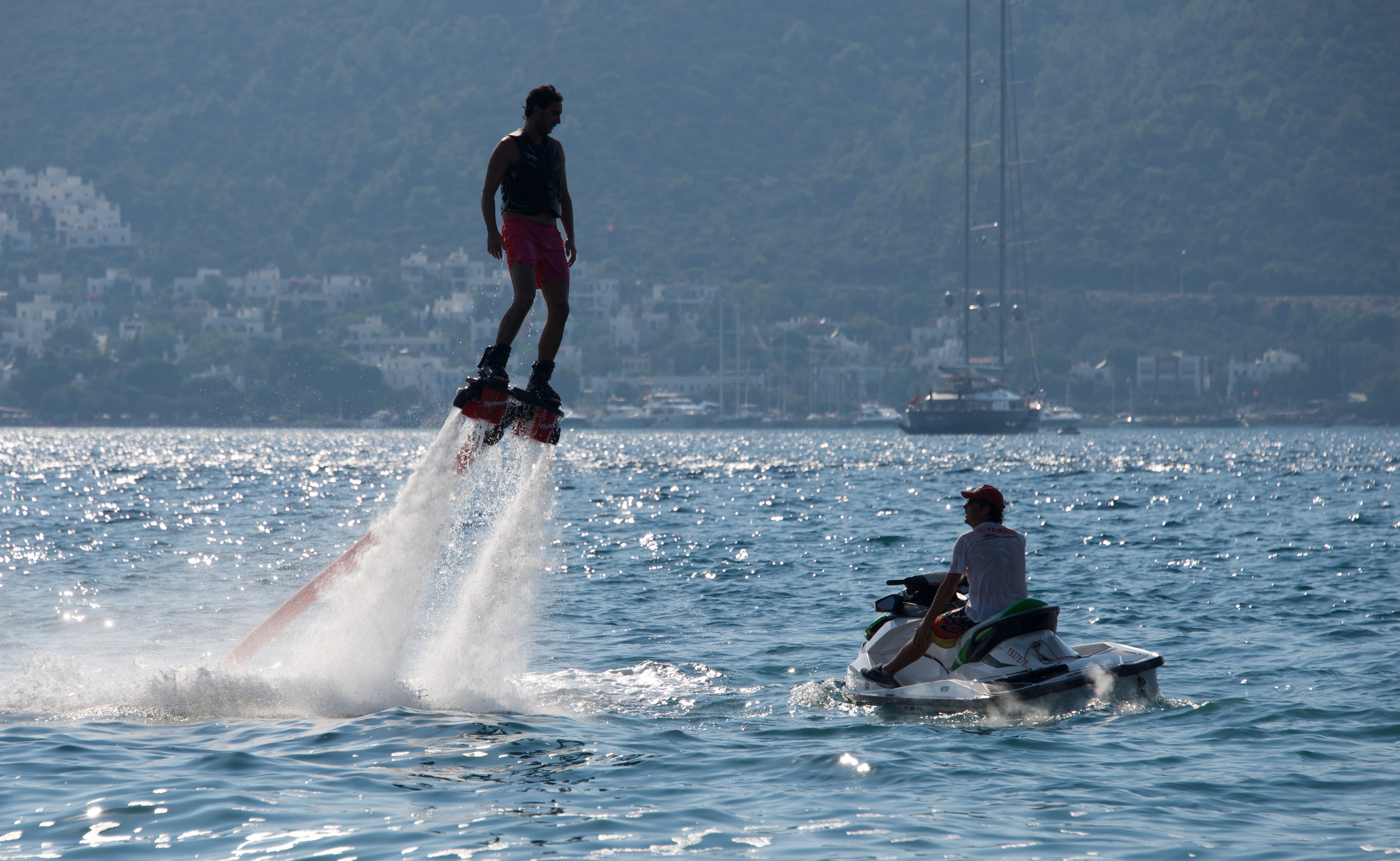 Flyboarder flying beside man on Jet Ski | Nick Dale – Private Tutor