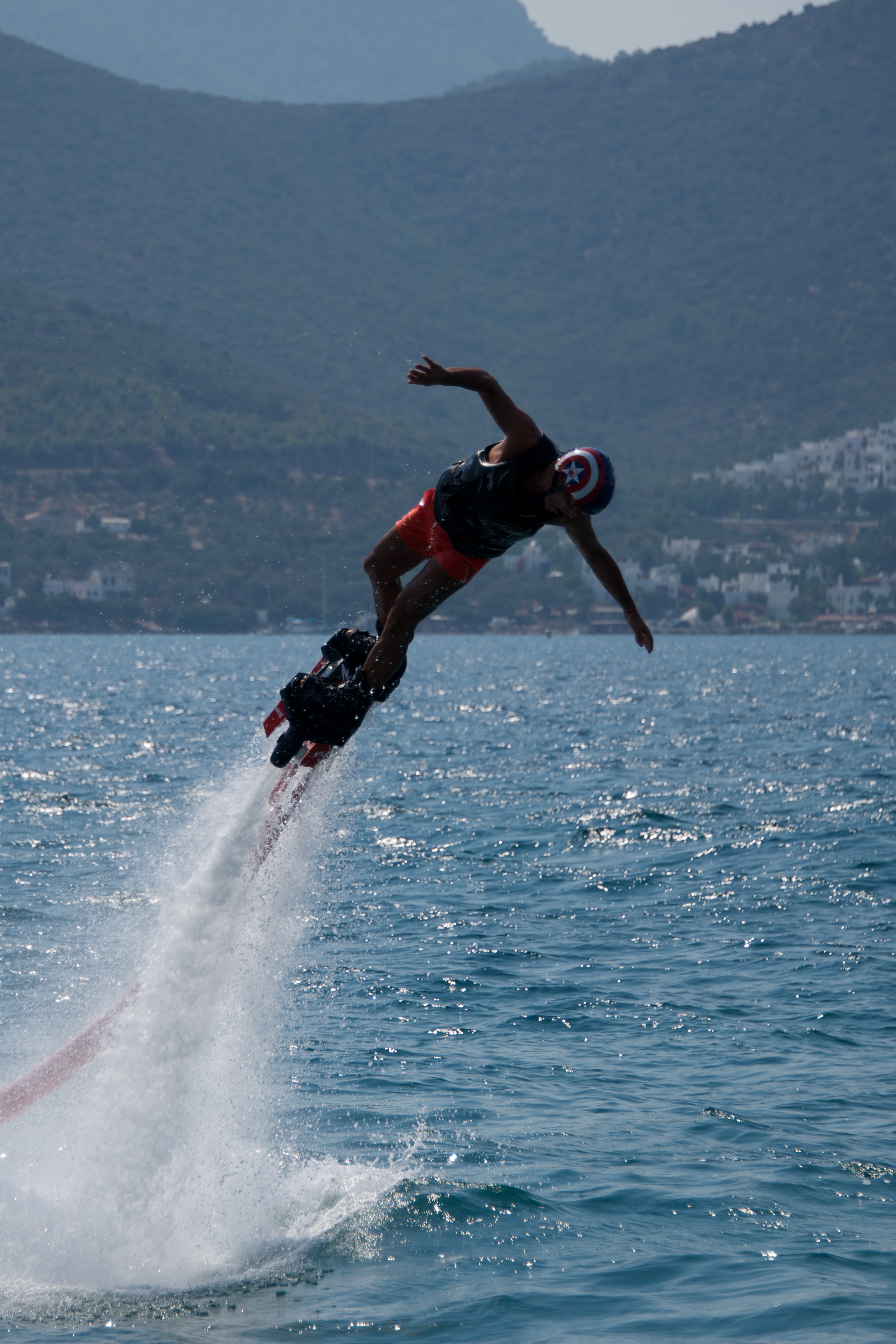 Flyboarder twisting into dive above backlit waves | Nick Dale – Private ...